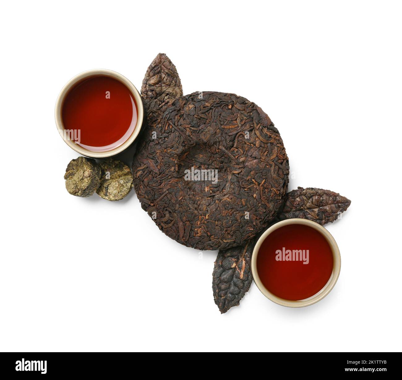 Dry pressed puer tea with cups on white background Stock Photo - Alamy