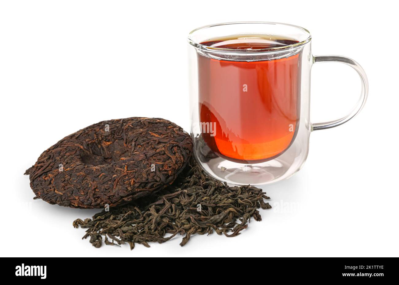 Dry pressed puer tea with glass on white background Stock Photo - Alamy