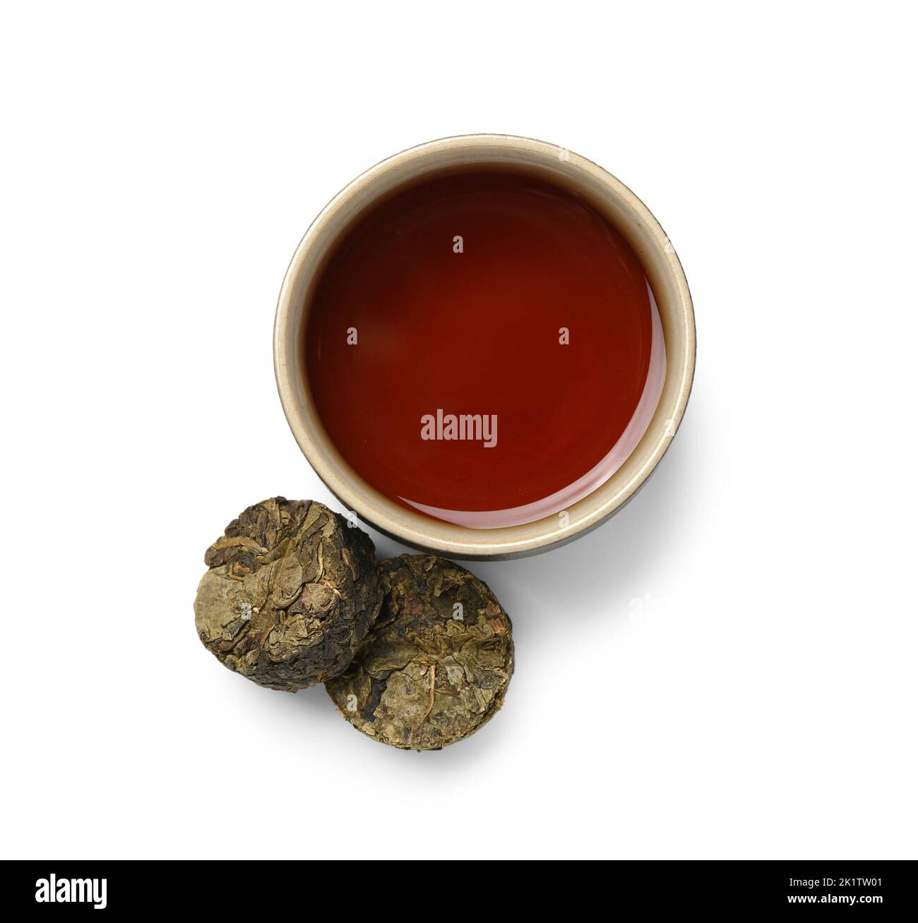 Dry pressed puer tea with cup on white background Stock Photo - Alamy