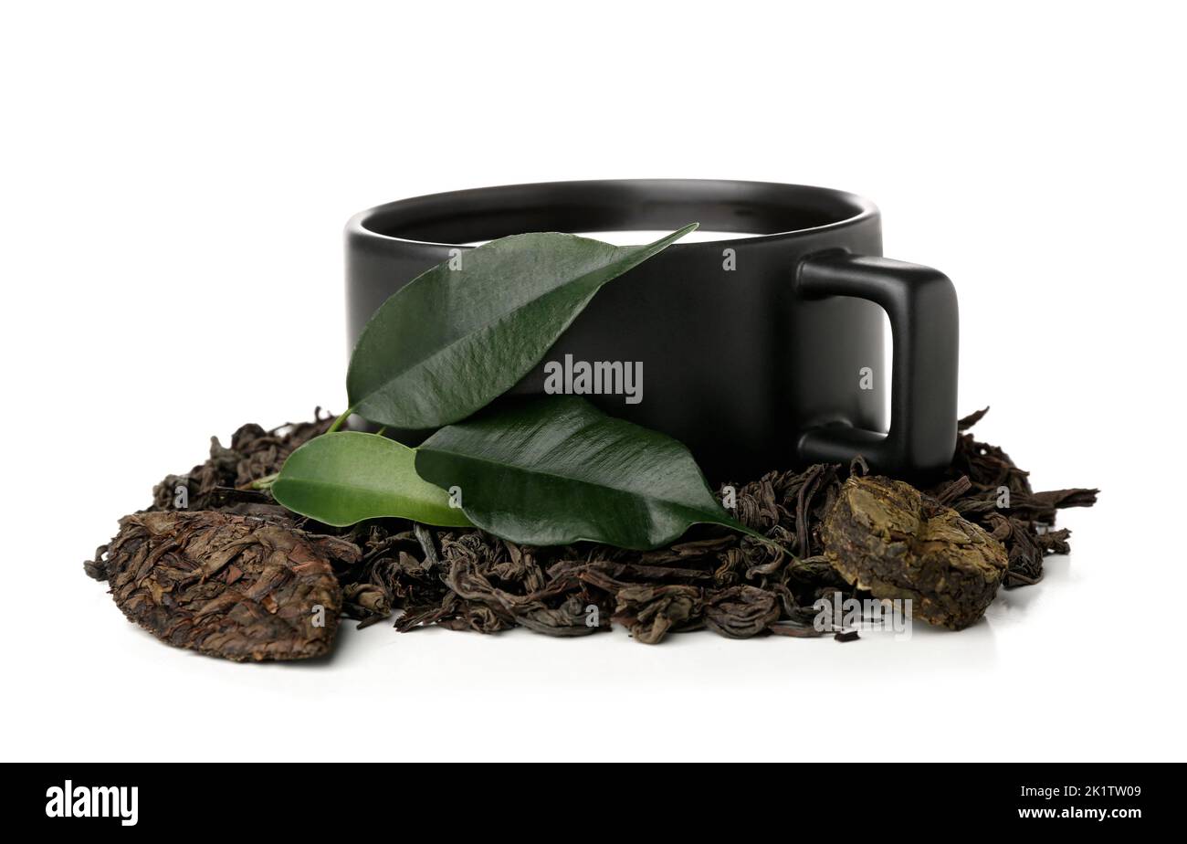 Dry pressed puer tea with cup and leaves on white background Stock ...