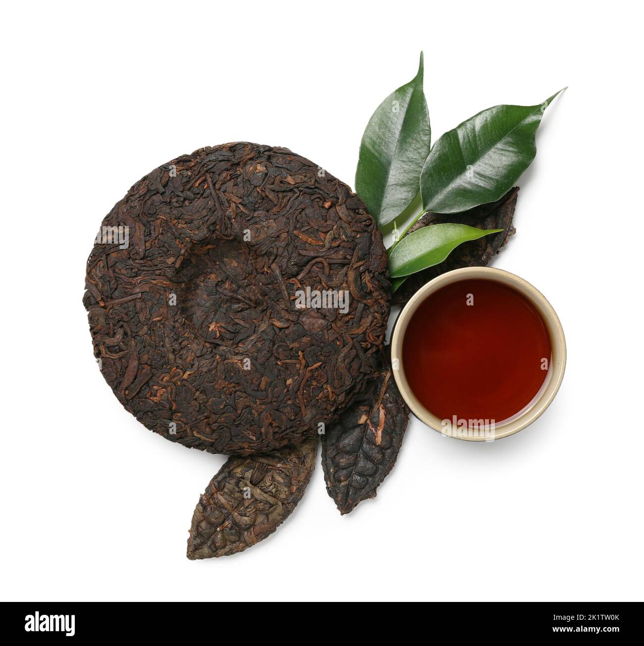 Dry pressed puer tea with cup and leaves on white background Stock ...