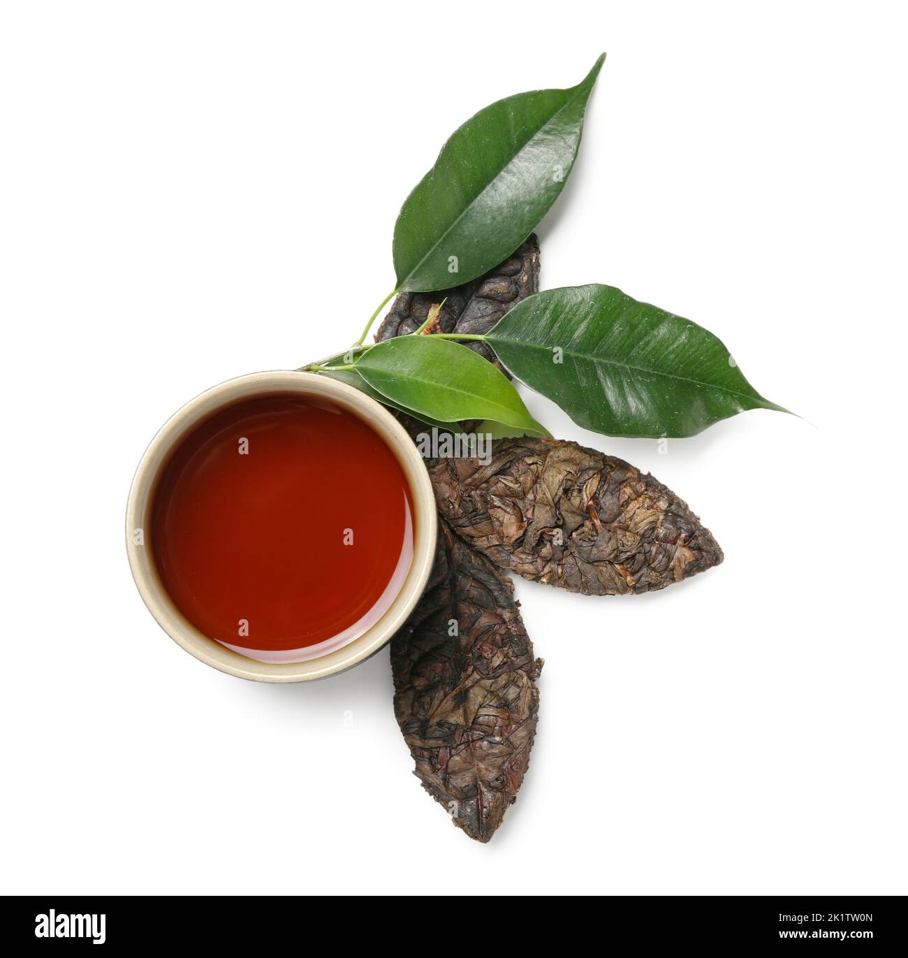 Dry pressed puer tea with cup and leaves on white background Stock ...