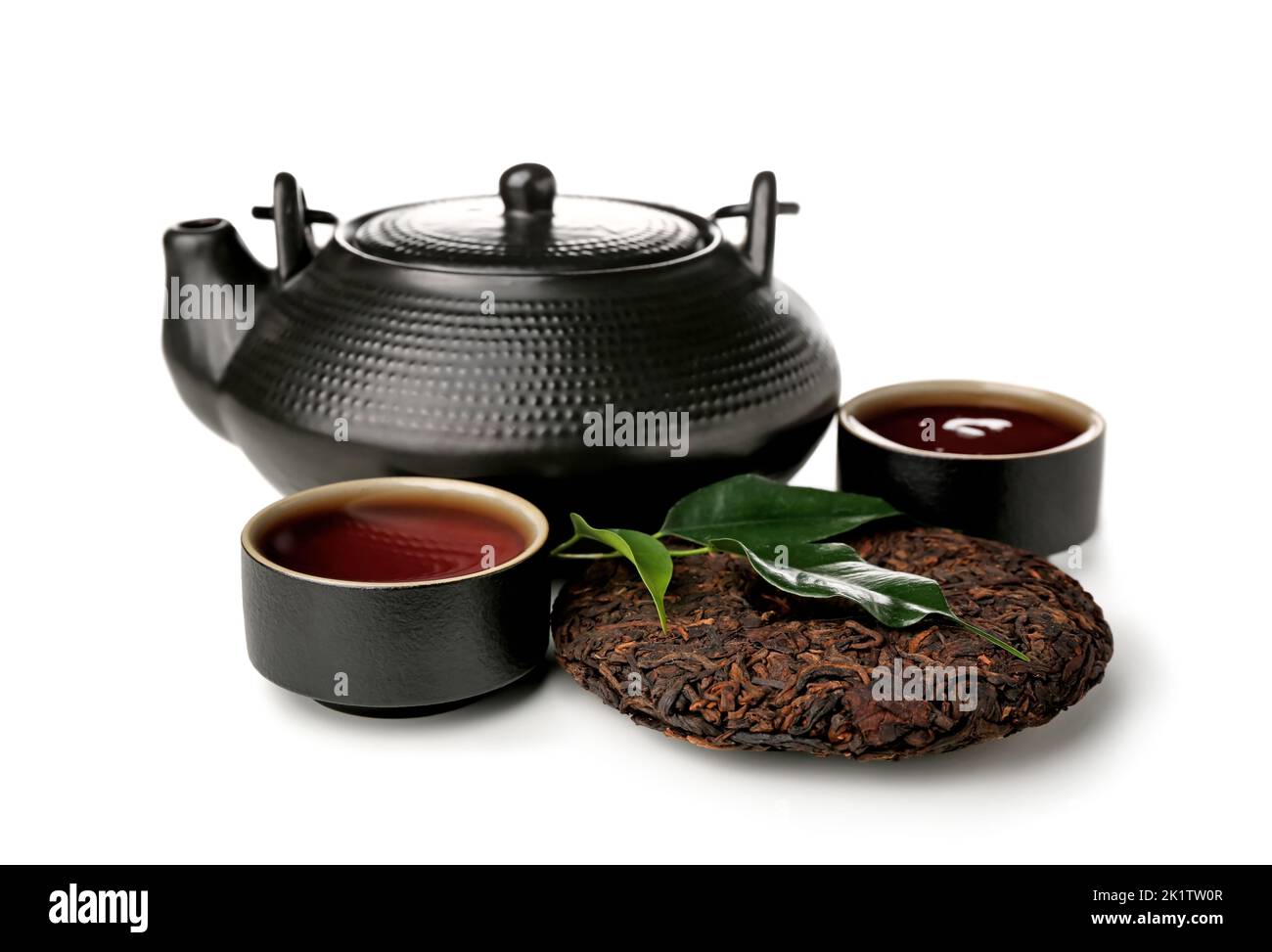 Dry pressed puer tea with cups and teapot on white background Stock ...