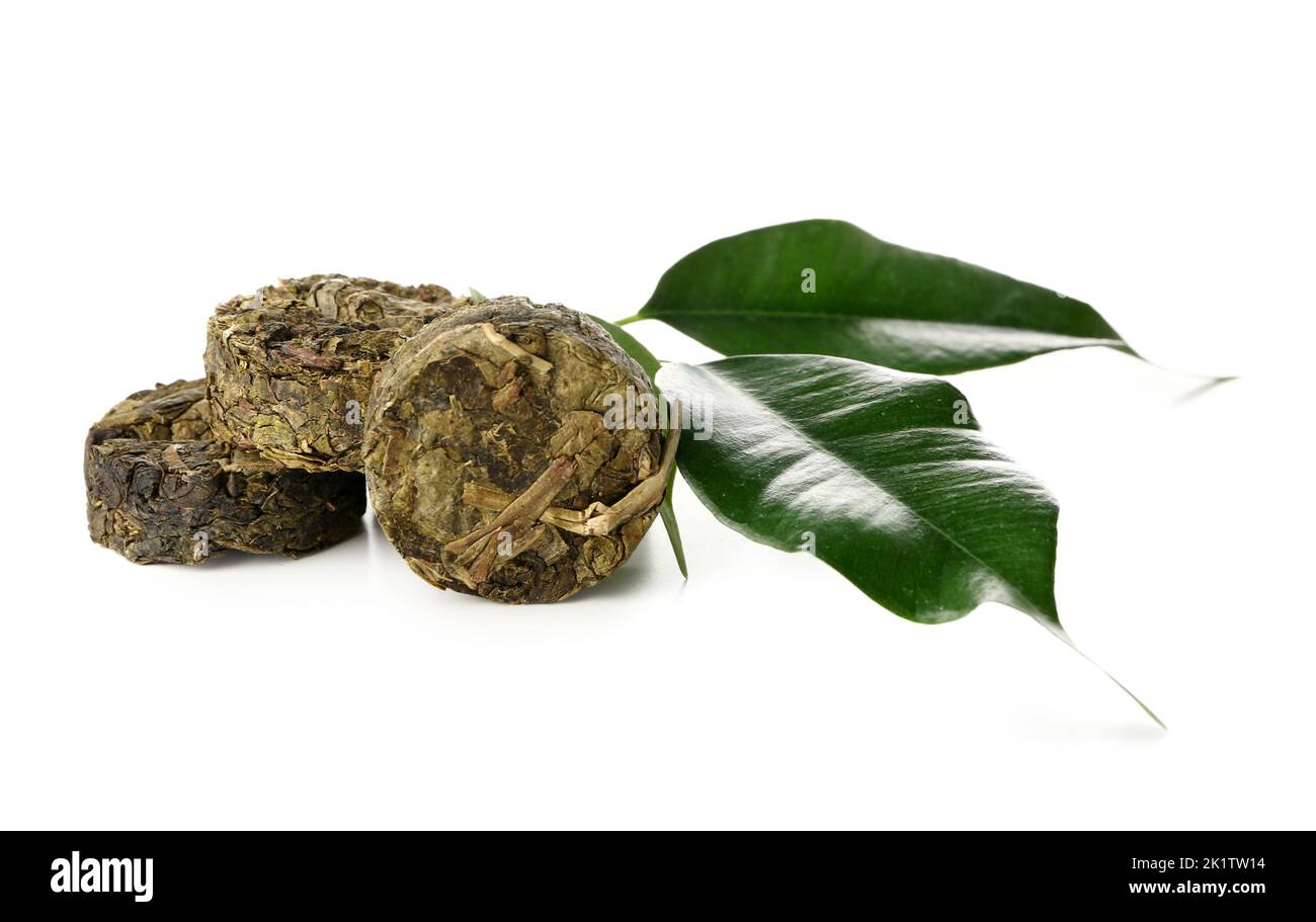 Dry pressed puer tea with leaves on white background Stock Photo - Alamy