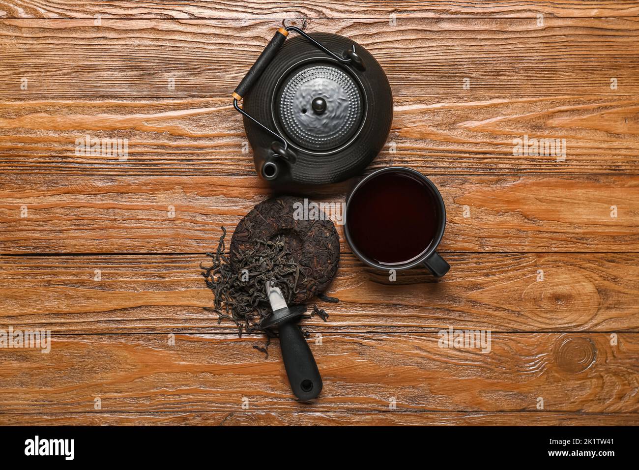 Teapot with cup of puer tea and knife on wooden background Stock Photo ...