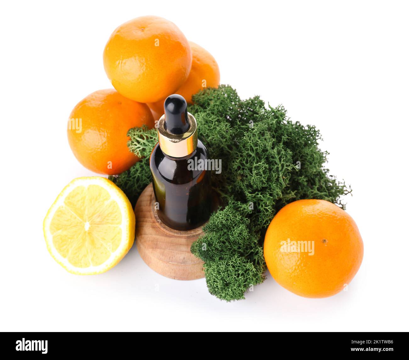 Composition with bottle of citrus serum, fruits and moss on white ...