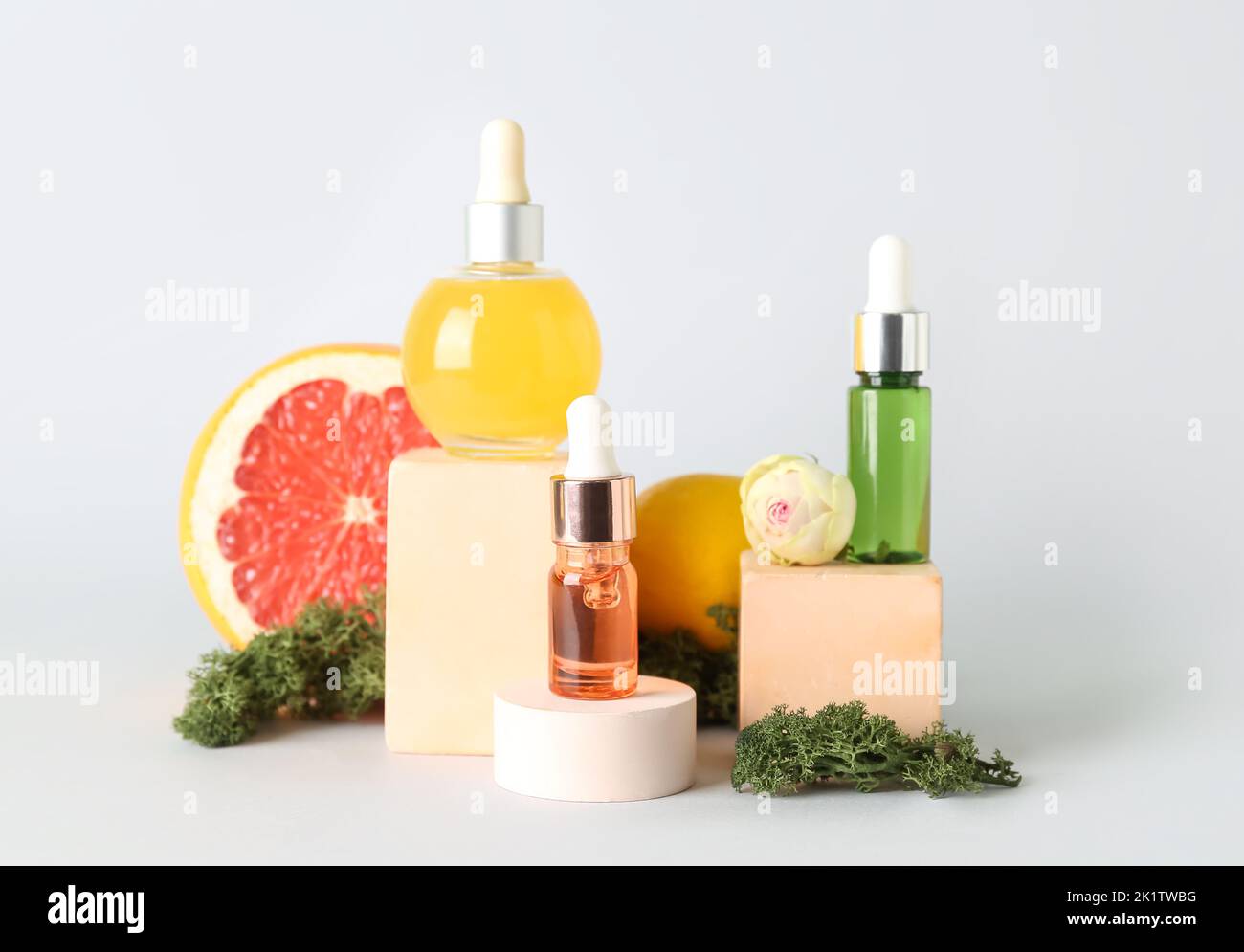 Composition with bottles of citrus serum on grey background Stock Photo ...