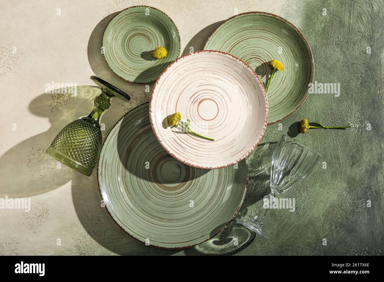 Beautiful plates with glasses and flowers on grunge background Stock ...