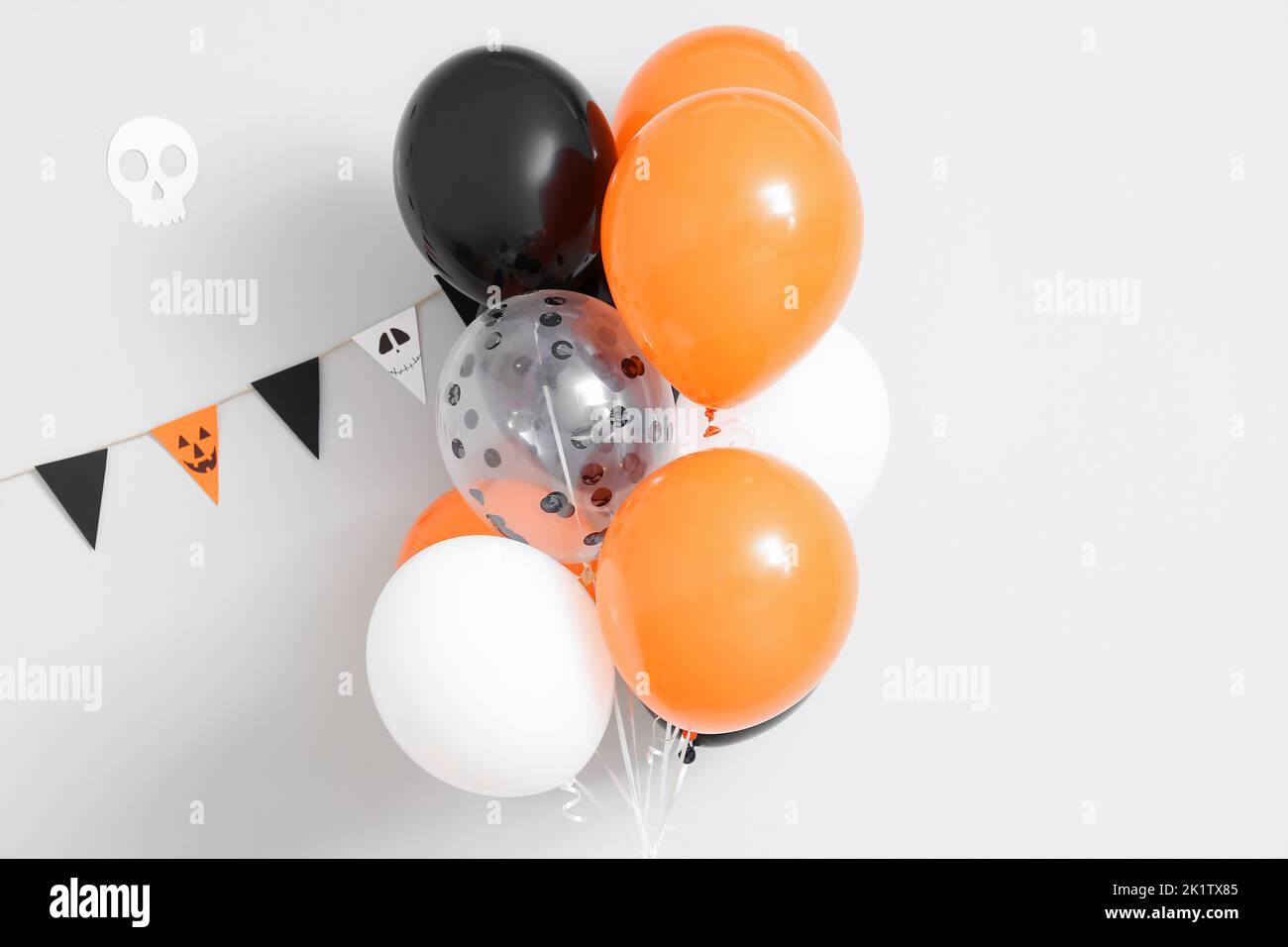 Halloween balloons near light wall Stock Photo - Alamy