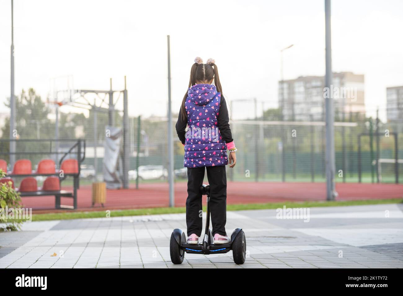 A little girl riding a electric scooter. Personal eco transport, gyro ...