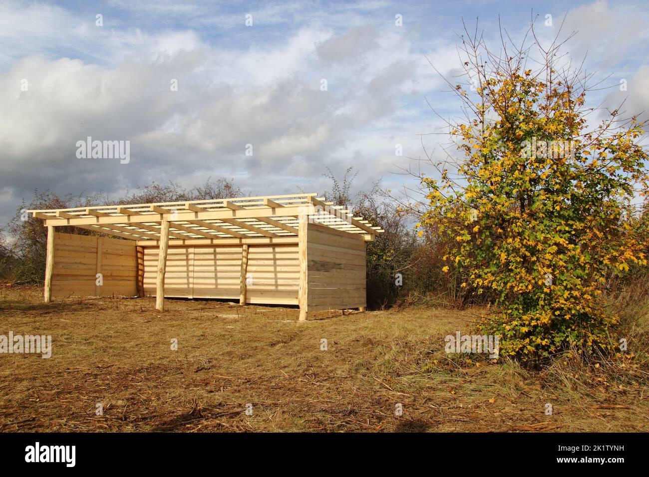 Wooden stables - shelter for domesticated animals on a pasture in the ...