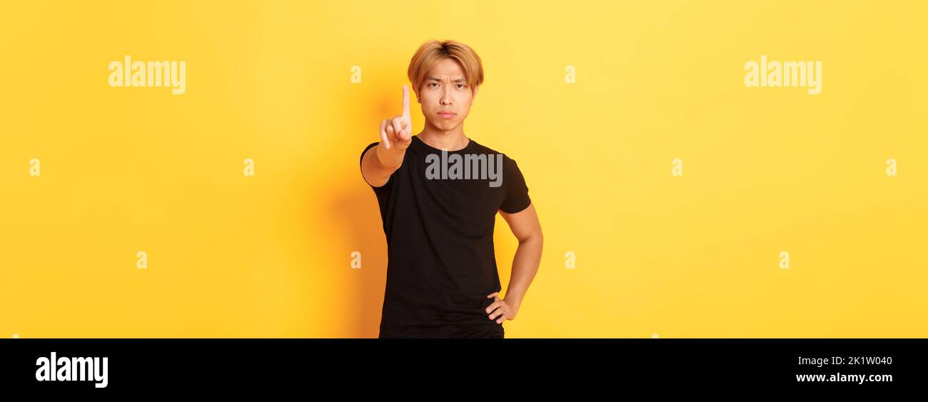 Portrait of serious-looking disappointed asian man shaking finger to ...