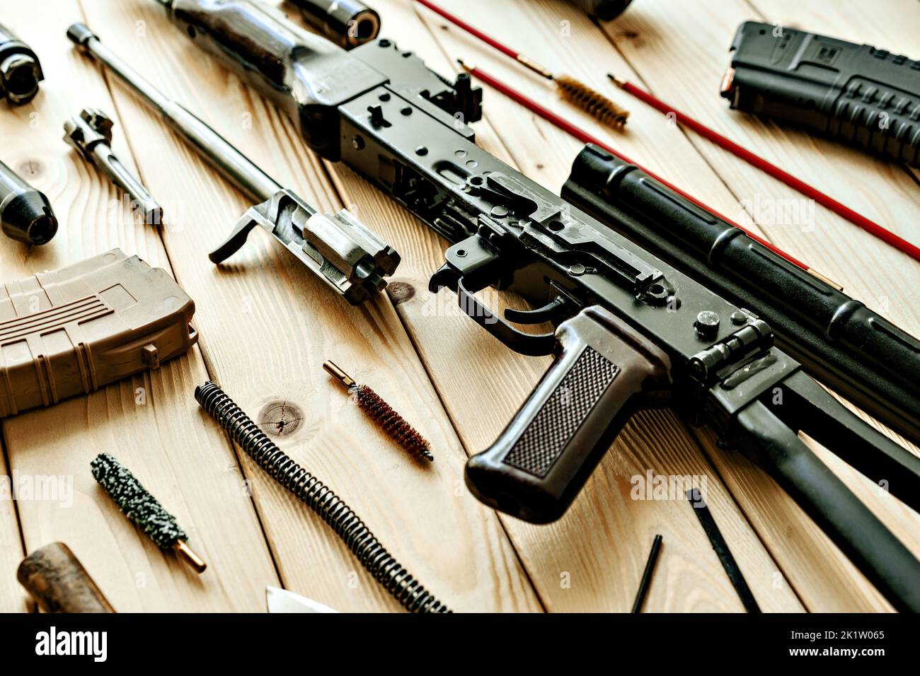 Disassembled rifle with cleaning tools on table of weapons workshop ...