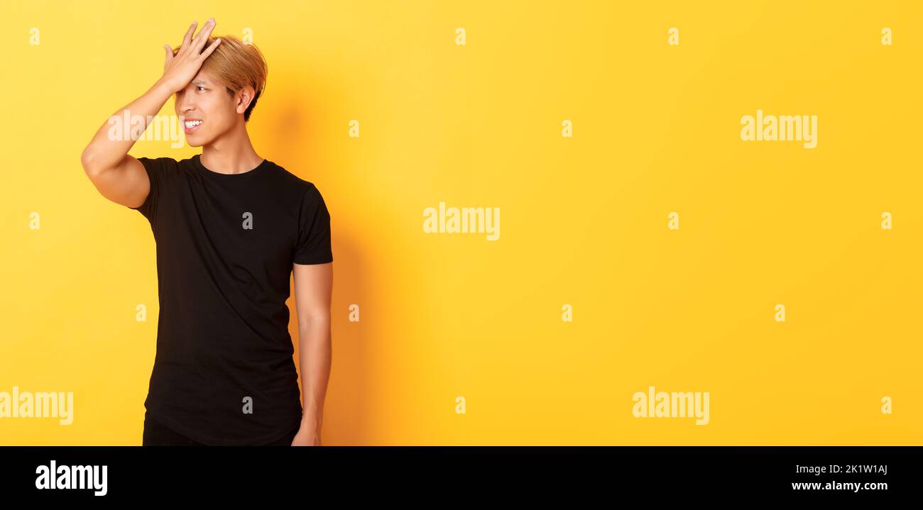 Upset and troubled asian guy snap forehead forgetful, standing over ...