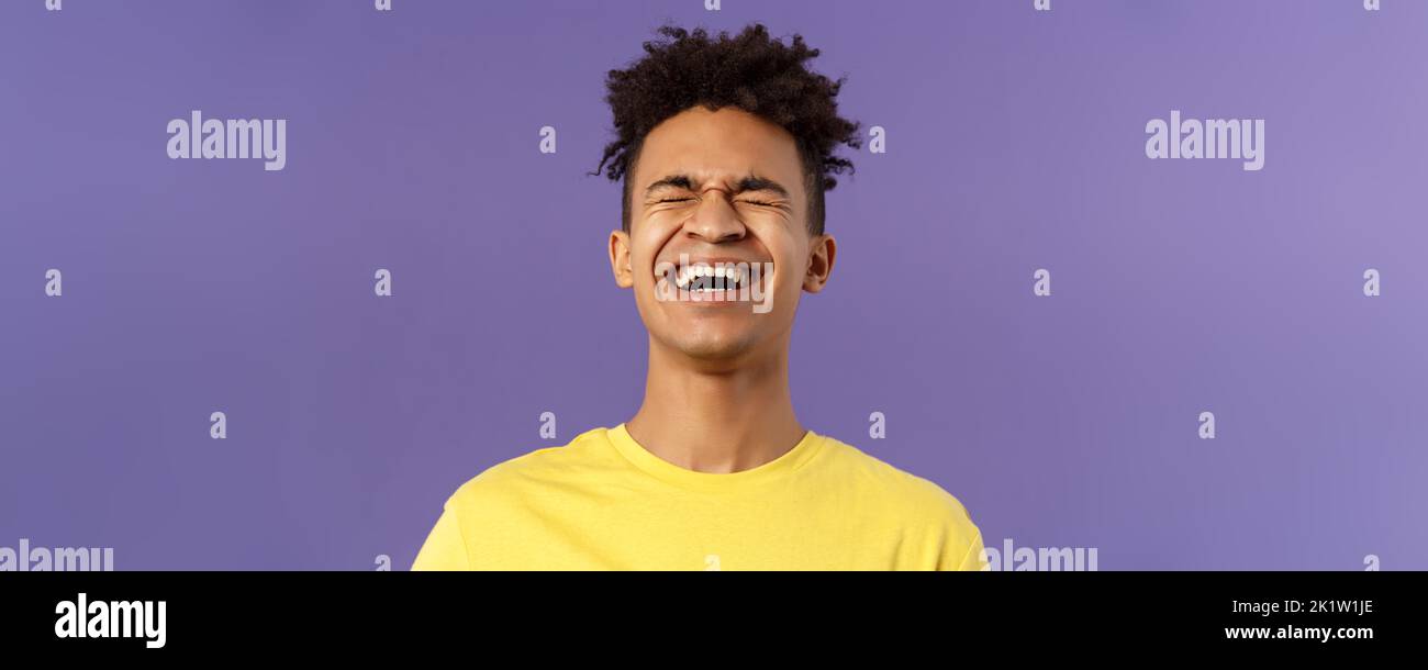 Close-up portrait of happy carefree young guy laughing loud, chuckling ...