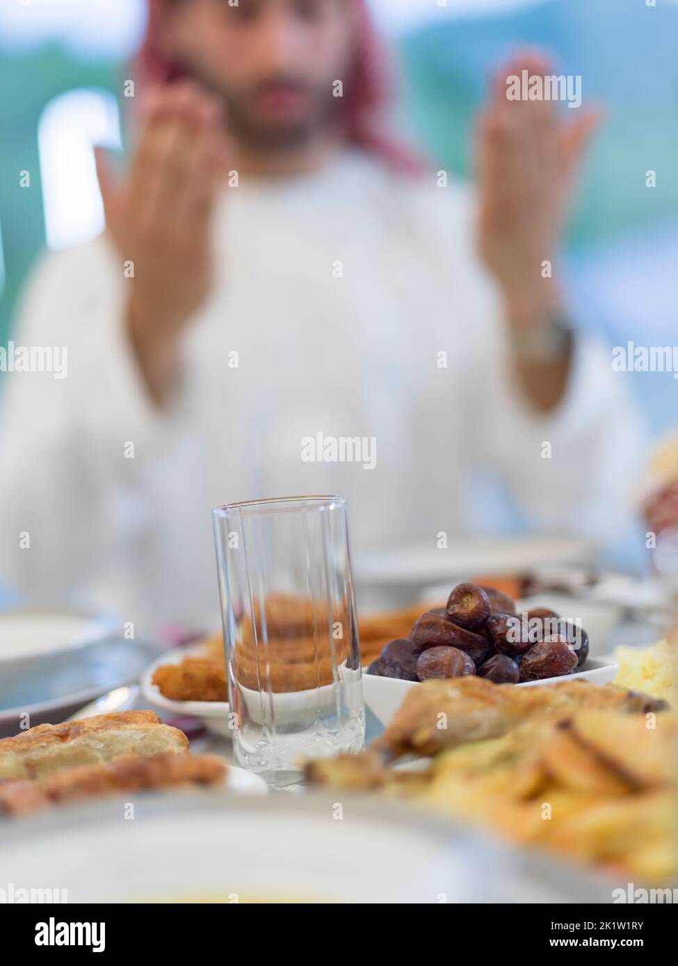 Muslim family making iftar dua to break fasting during Ramadan Stock ...