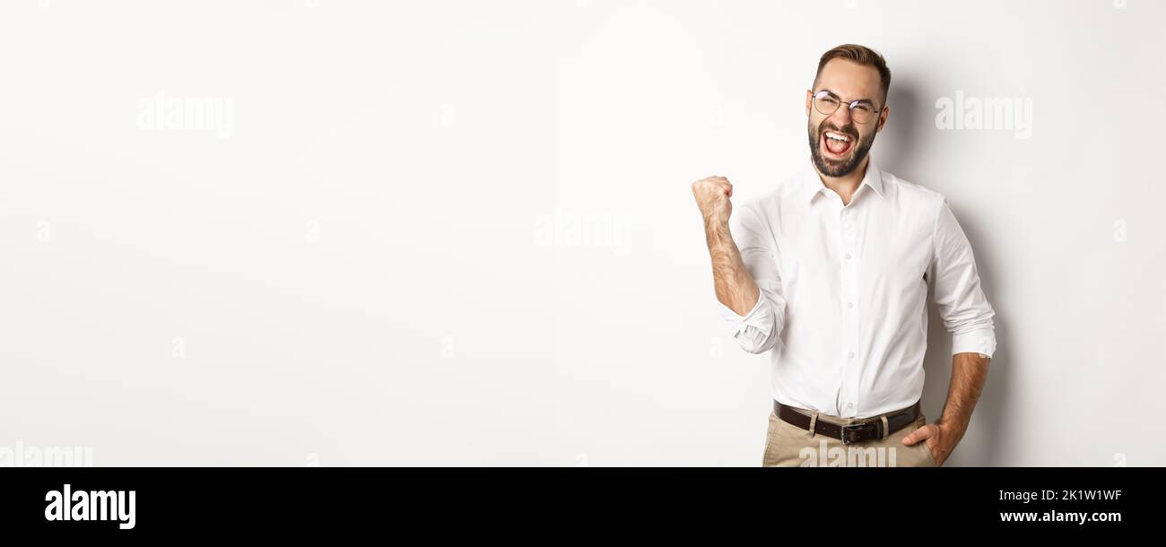 Successful businessman rejoicing, making fist pump and saying yes ...