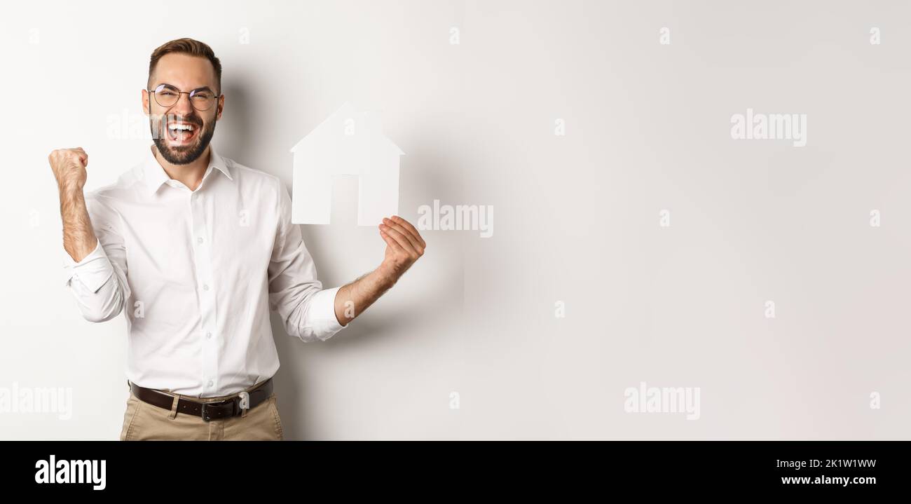 Real estate. Satisfied man rejoicing of founding perfect home apartment ...