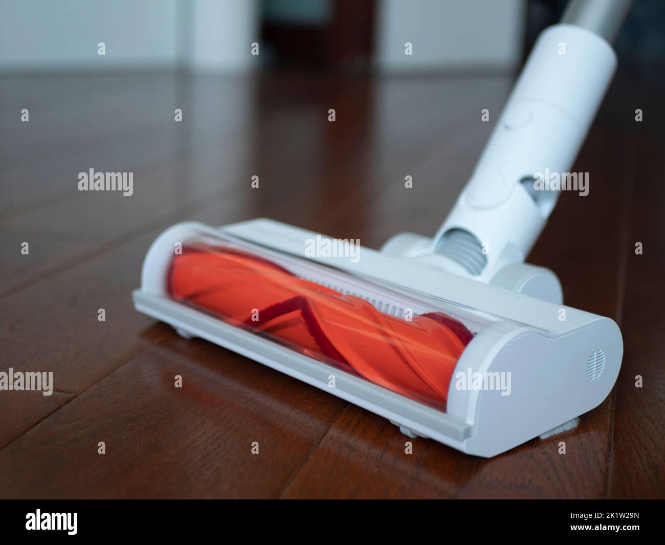White vacuum cleaner with V-shaped rotating roller head, selective ...