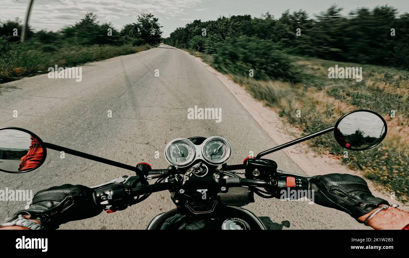 First person view, biker riding retro motorcycle. Fast driving on free ...