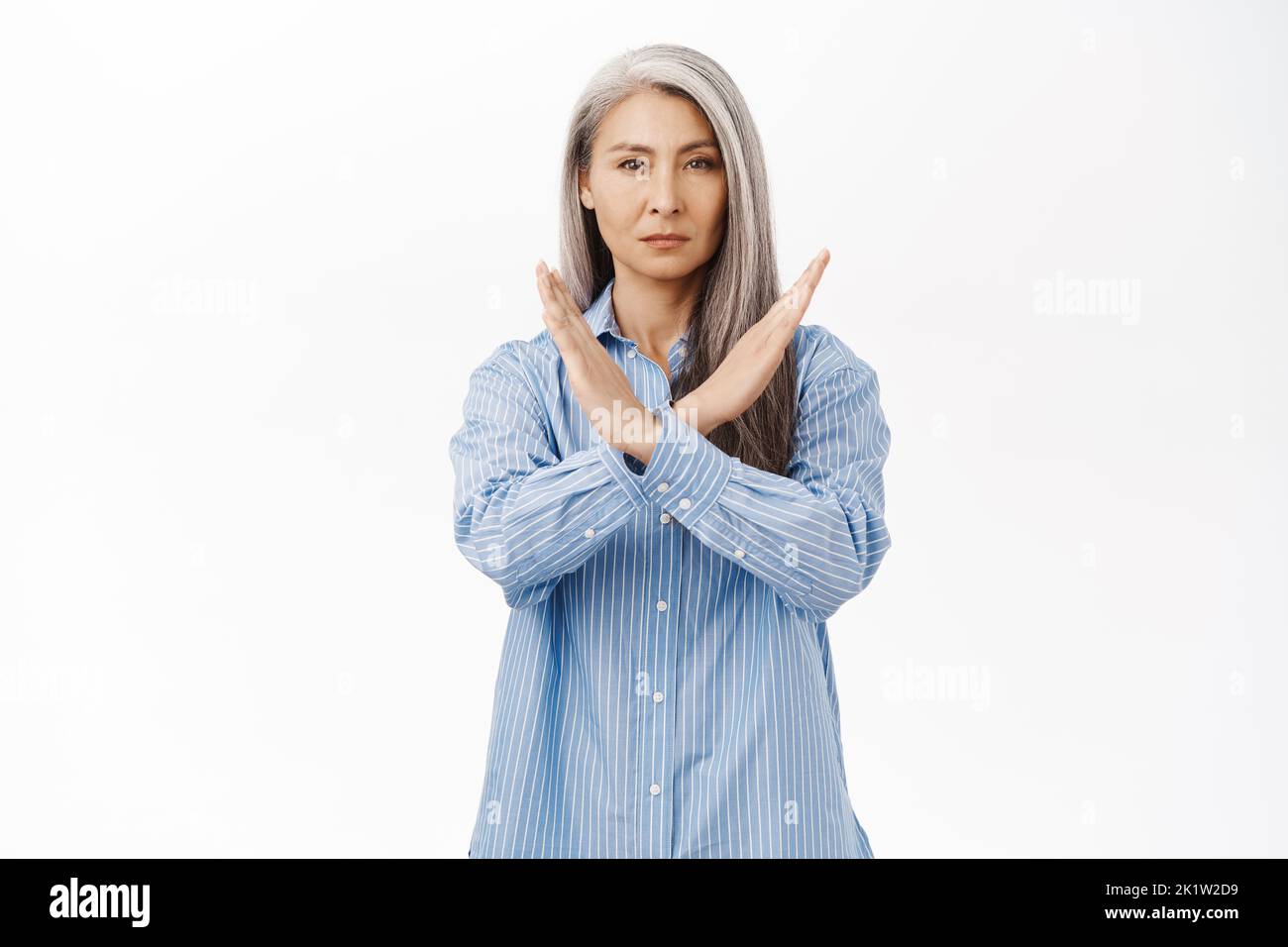 Stop. Serious asian woman showing prohibit, forbid gesture, extending ...