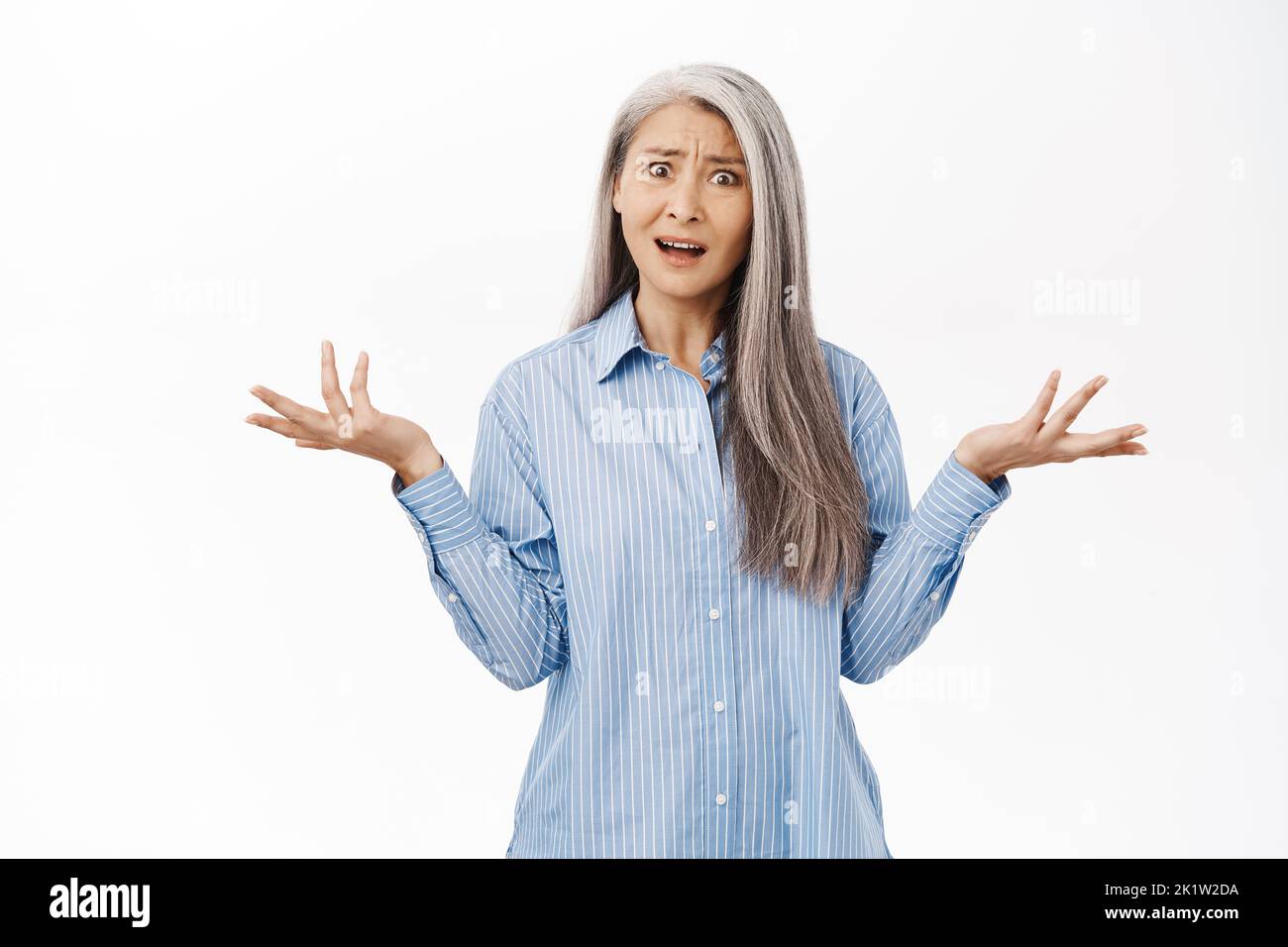 Confused japanese middle aged woman looking questioned and frustrated ...