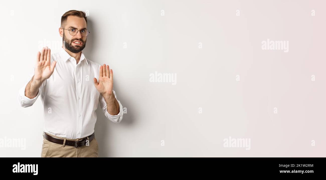 Displeased man rejecting something disturbing, showing stop sign and ...