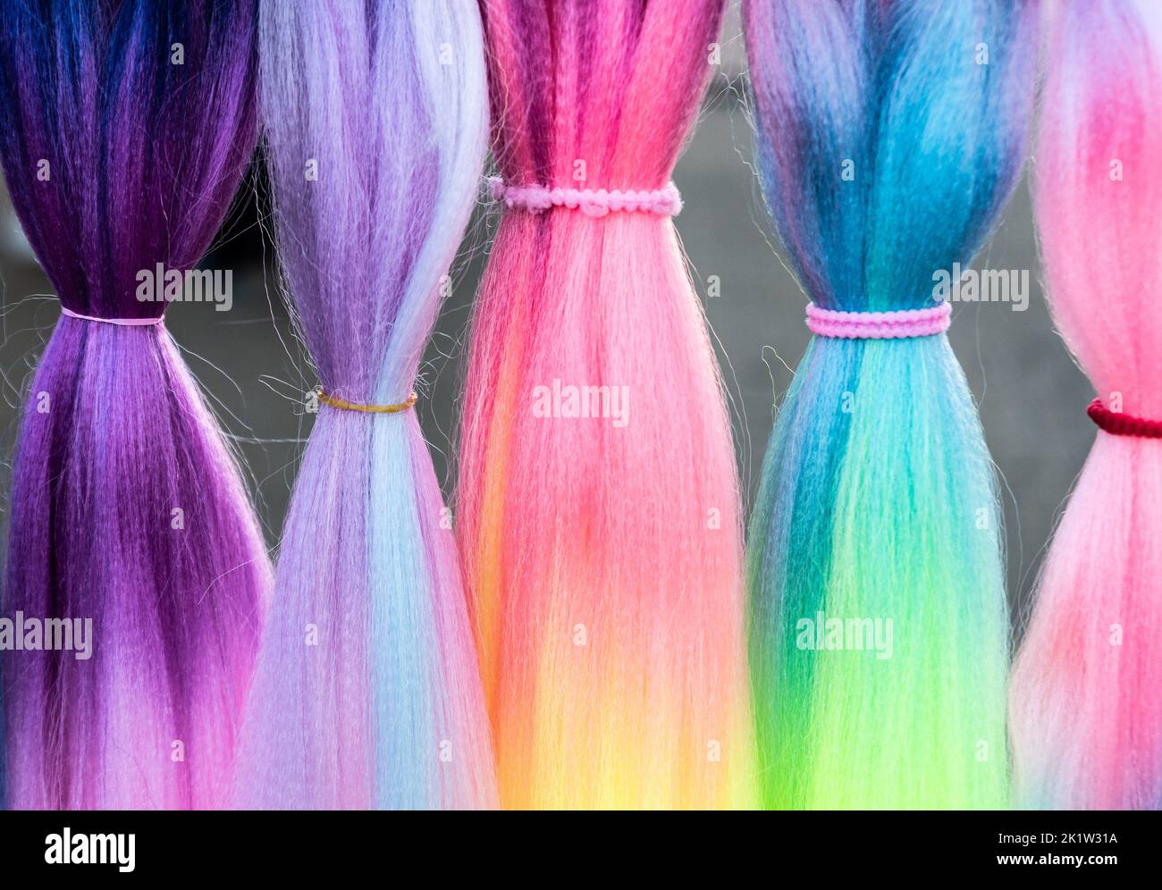Colored synthetic hair. Strands of colorful artificial hair to attach ...