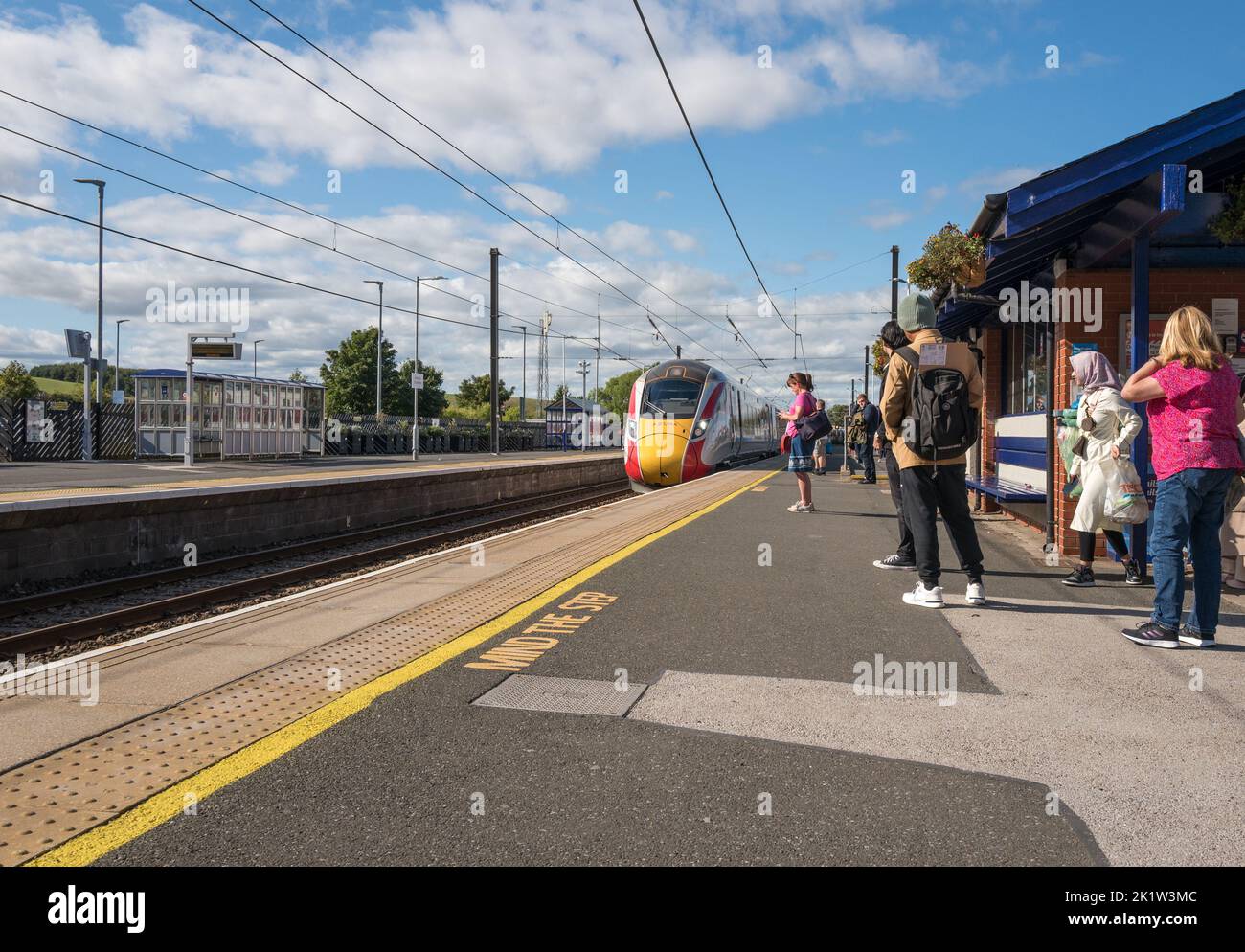 Azuma intercity electric train stopping at Alnmouth East Coast Main Line railway station ...