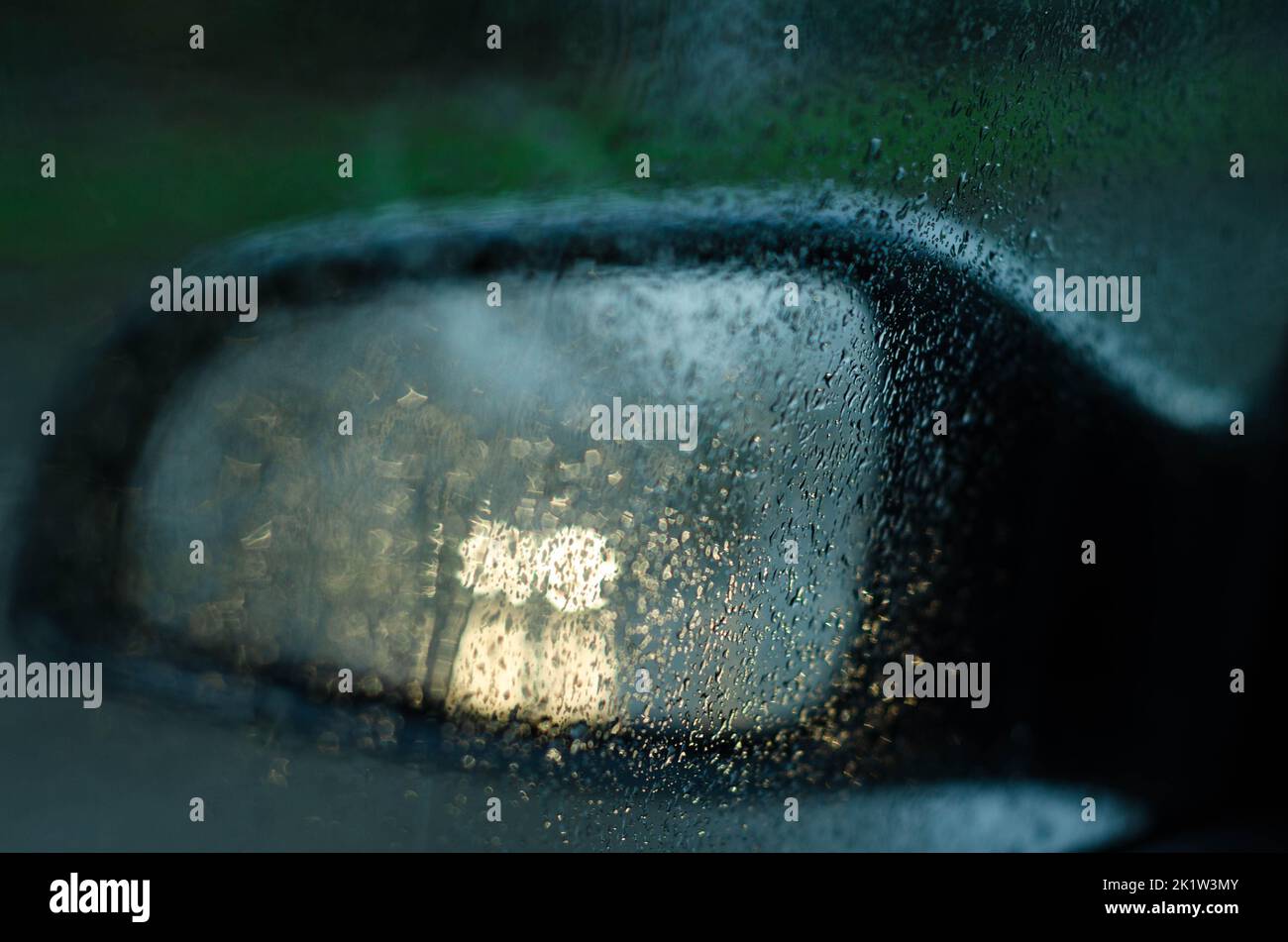 driving car on road in the rain with raindrop over the wind shield ...