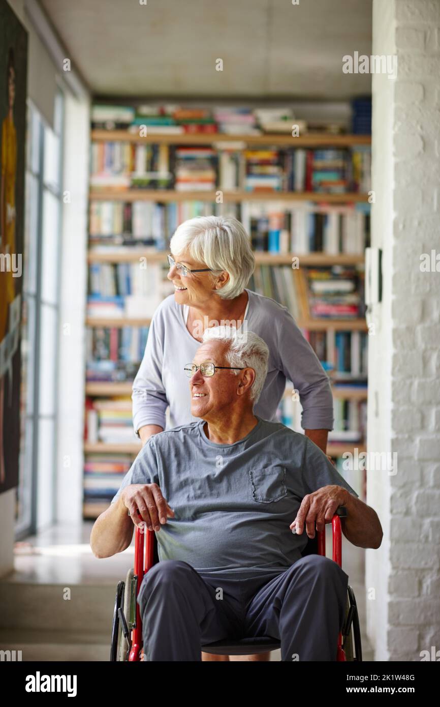 Spousal support in the senior years. a senior woman standing behind her ...