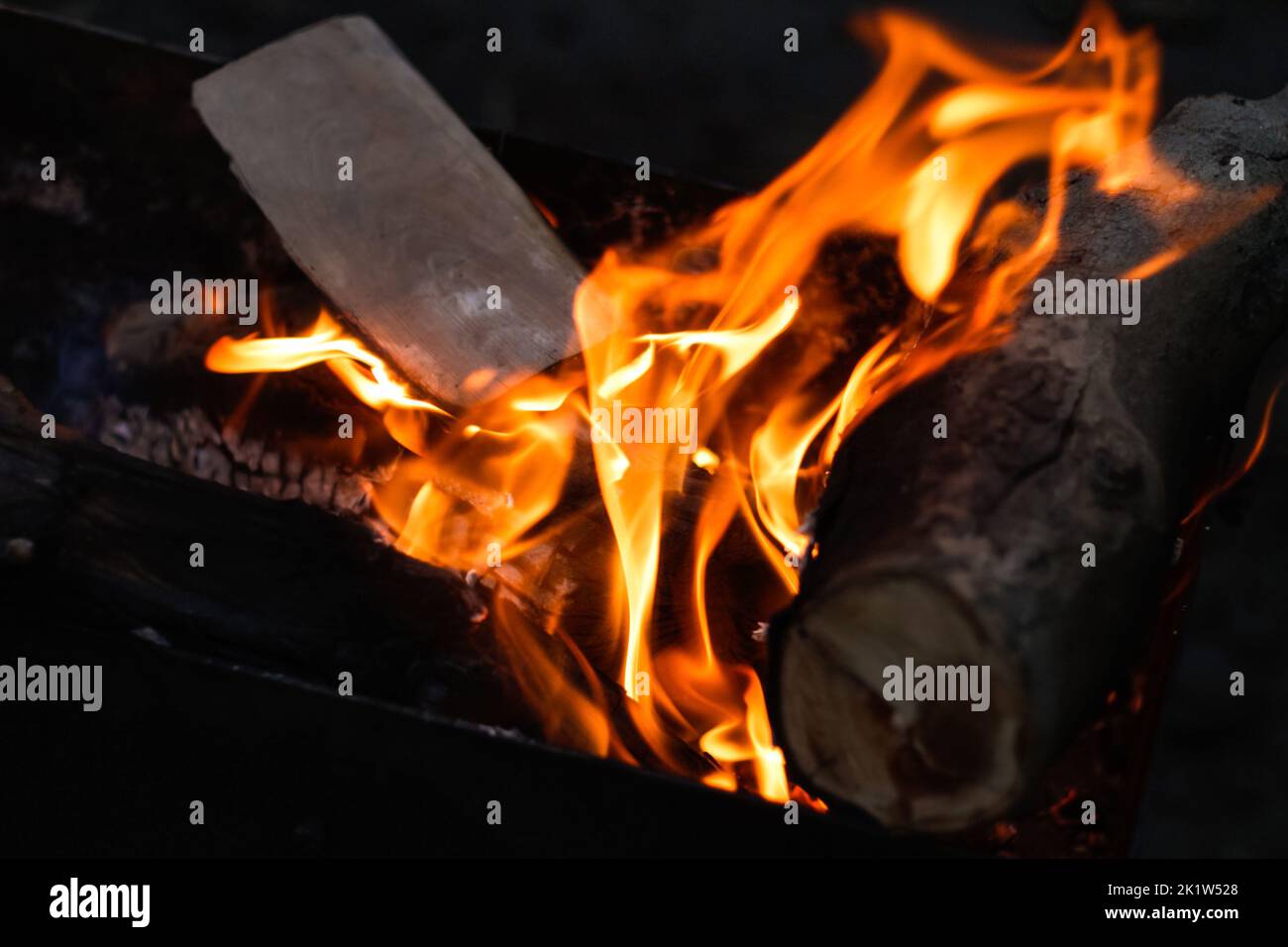 Defocus fire flame firewood fireplace wood. Bright flames burning wood ...