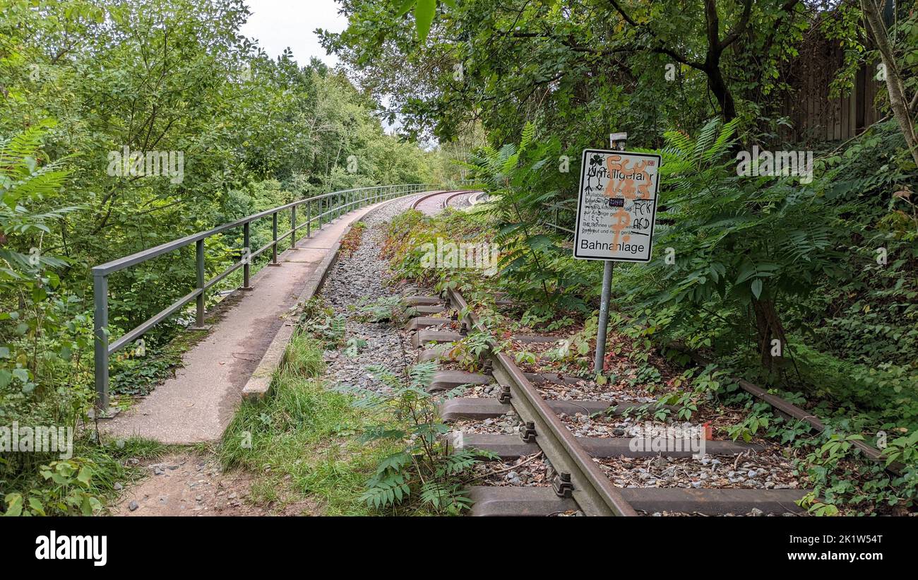 An abandoned rails of the DB running towards a bridge with an accident ...