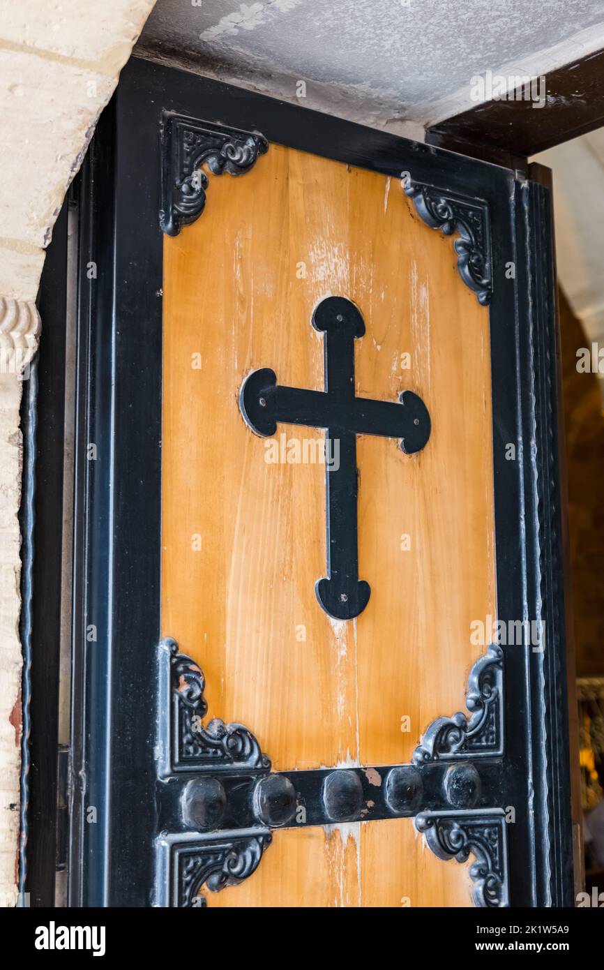 A vertical shot of an old door with a big cross Stock Photo - Alamy