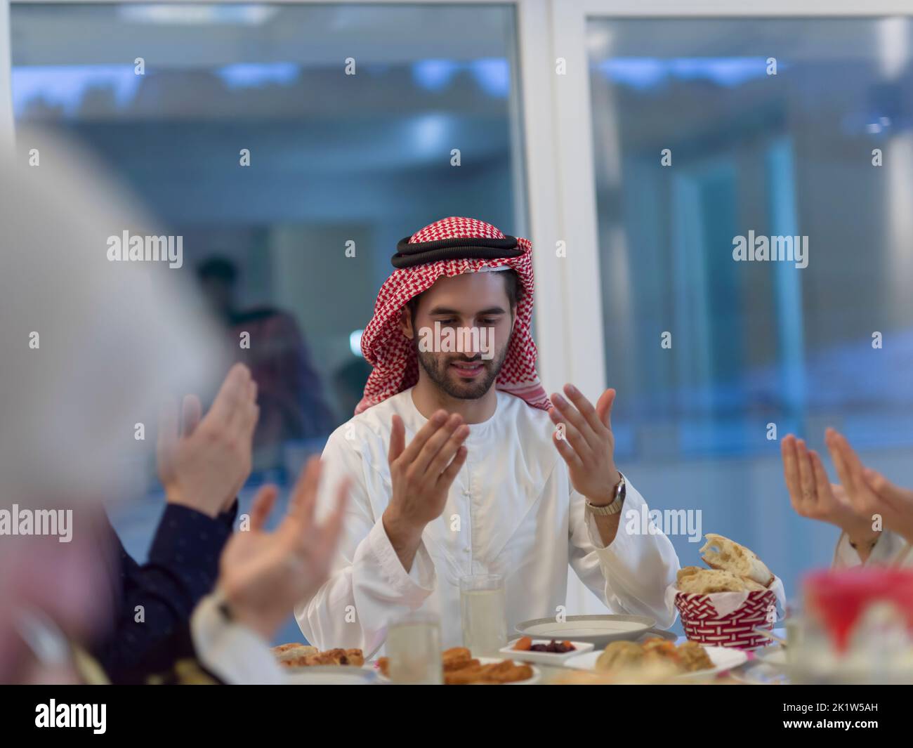 Muslim family making iftar dua to break fasting during Ramadan Stock ...