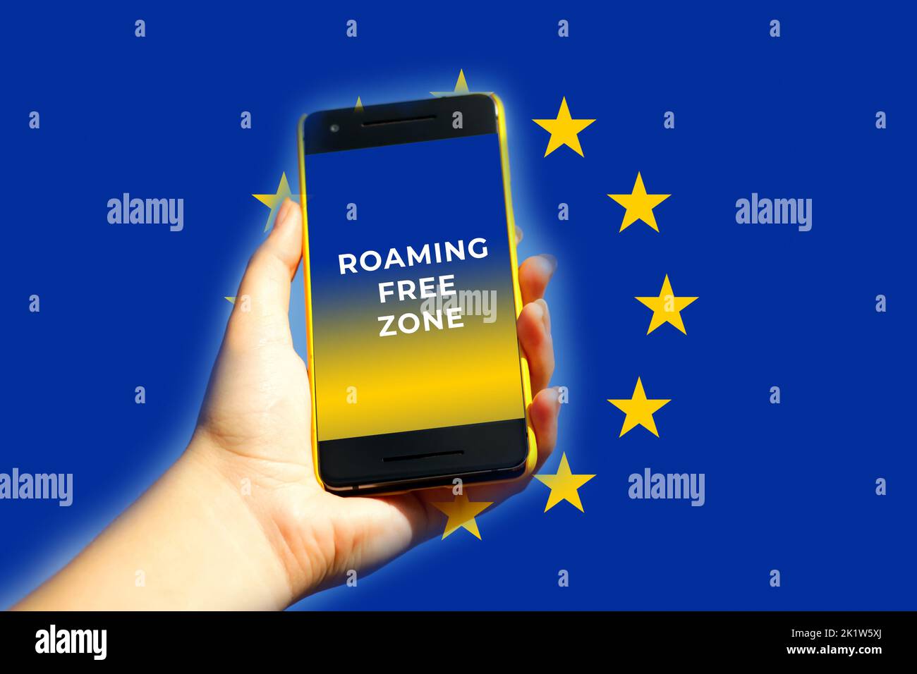 Roaming Free Euro Zone. Woman hand holding black smartphone in yellow ...