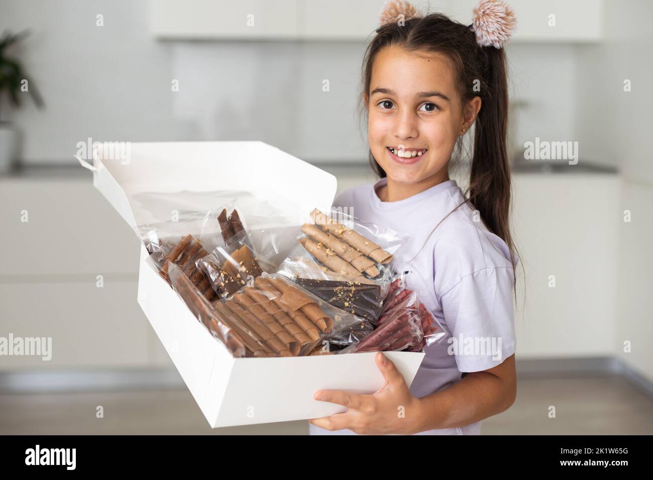 Little cute girl eating berry homemade paste candy Stock Photo - Alamy