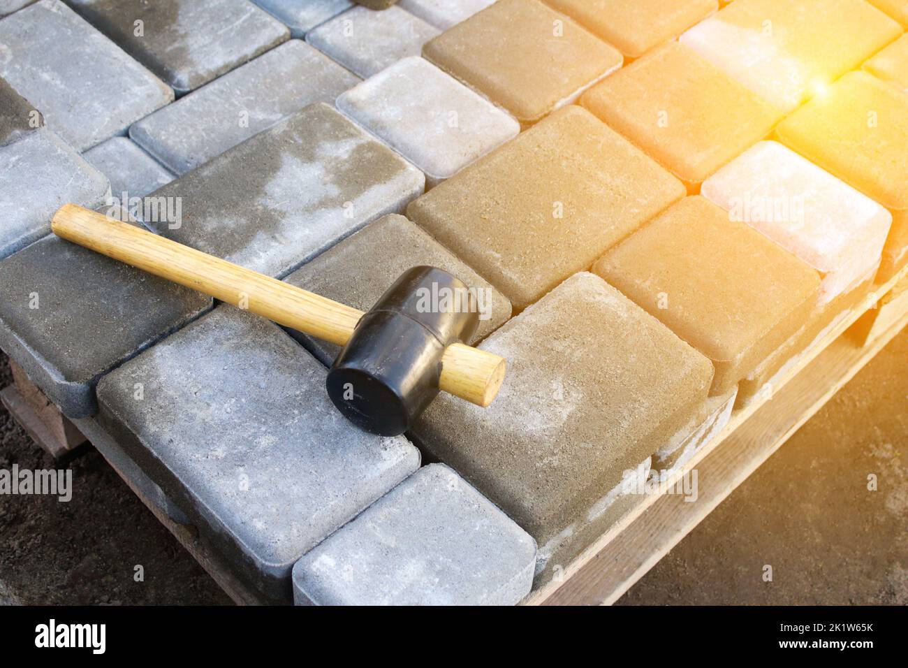 Defocus paving hammer. Stack of paving stones. Garden brick pathway ...