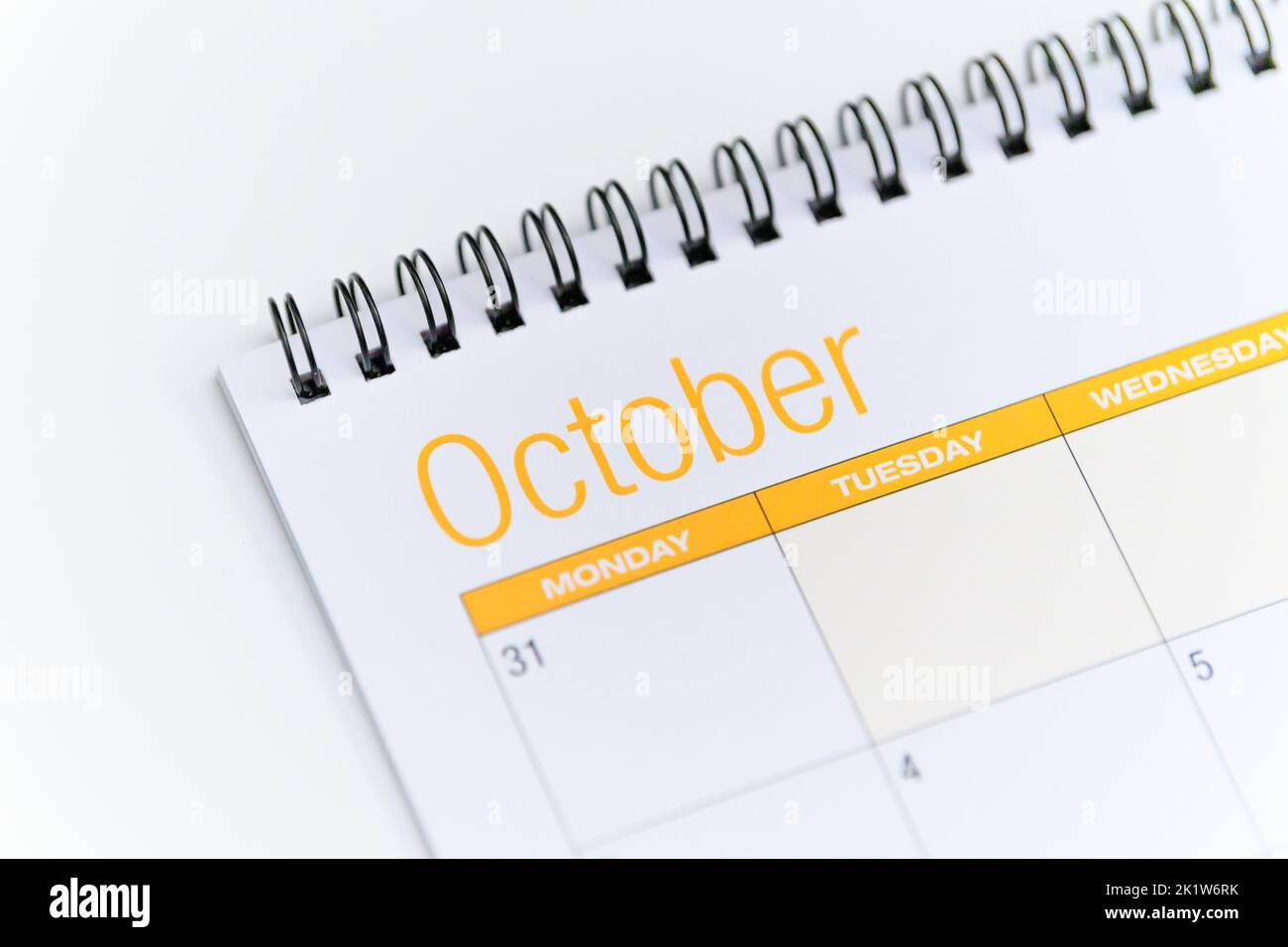 A closeup of a calendar opened on the October month page and placed on ...
