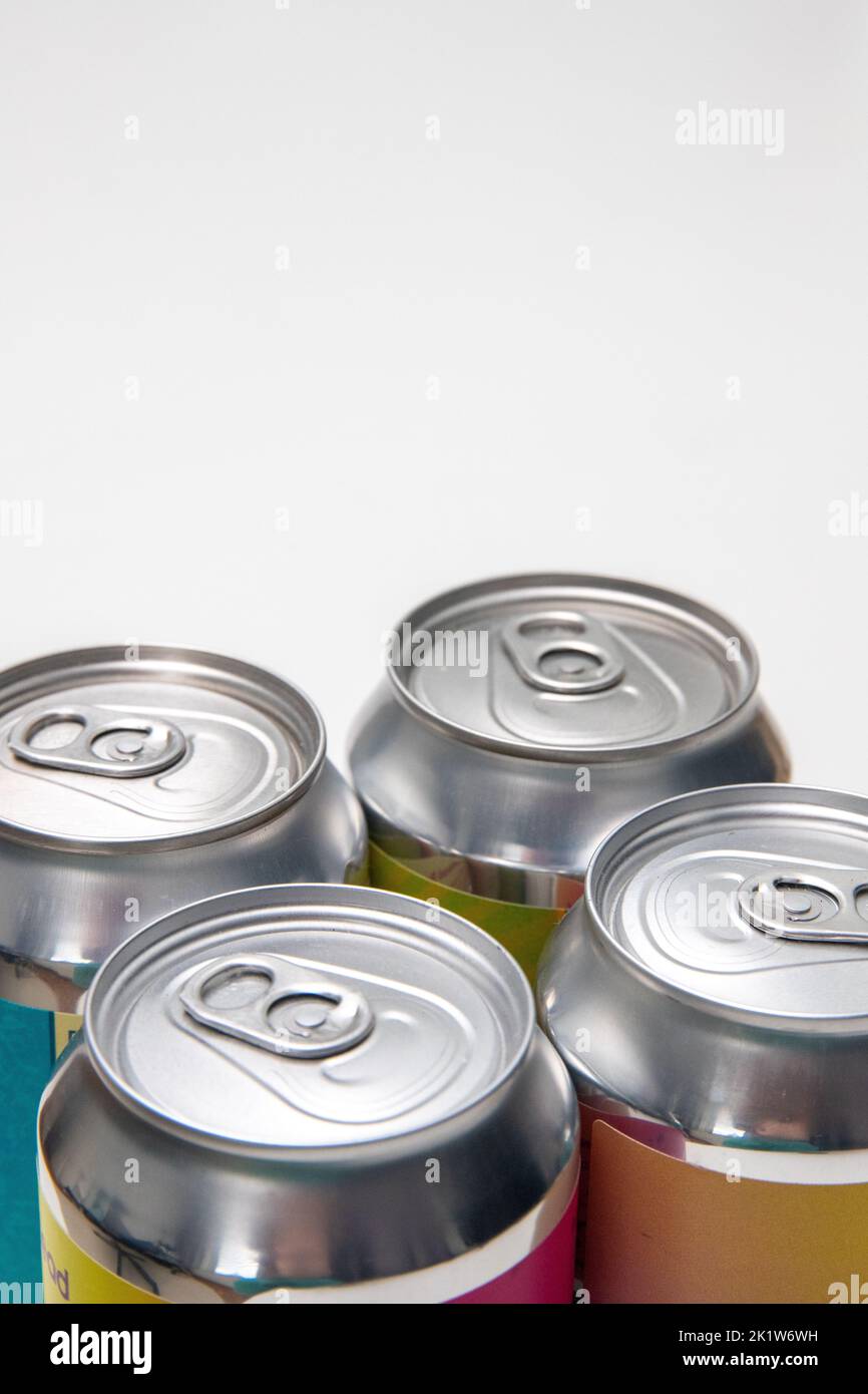 A vertical closeup view of four metal beverage cans Stock Photo - Alamy