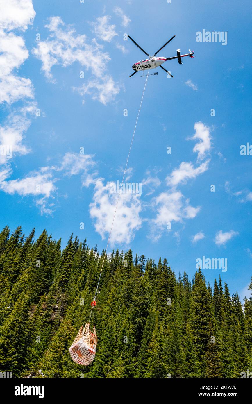 Helicopter flies in seasonal supplies to the Lake Agnes Tea House; Lake ...