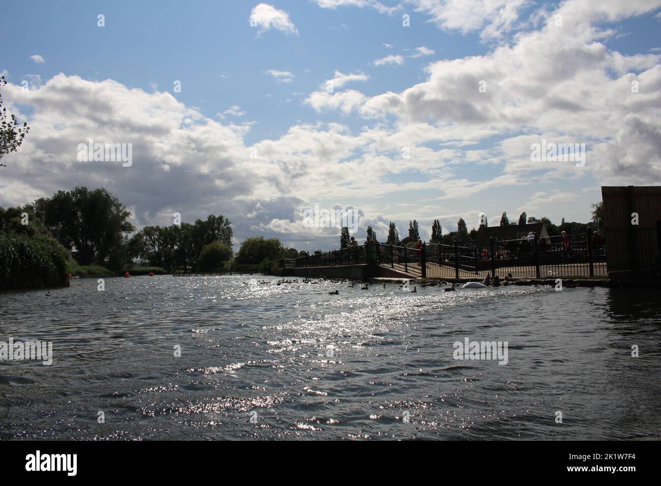 Lake/River reflecting sun rays Stock Photo - Alamy