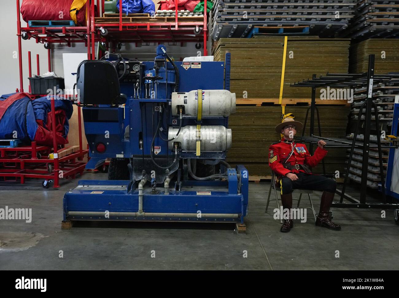 An RCMP officer sits next to a Zamboni while waiting for a change of ...