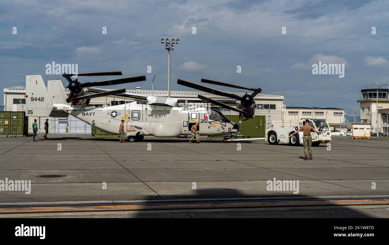 A U.S. Navy V-22 Osprey is transported onto a cargo ship during a ...