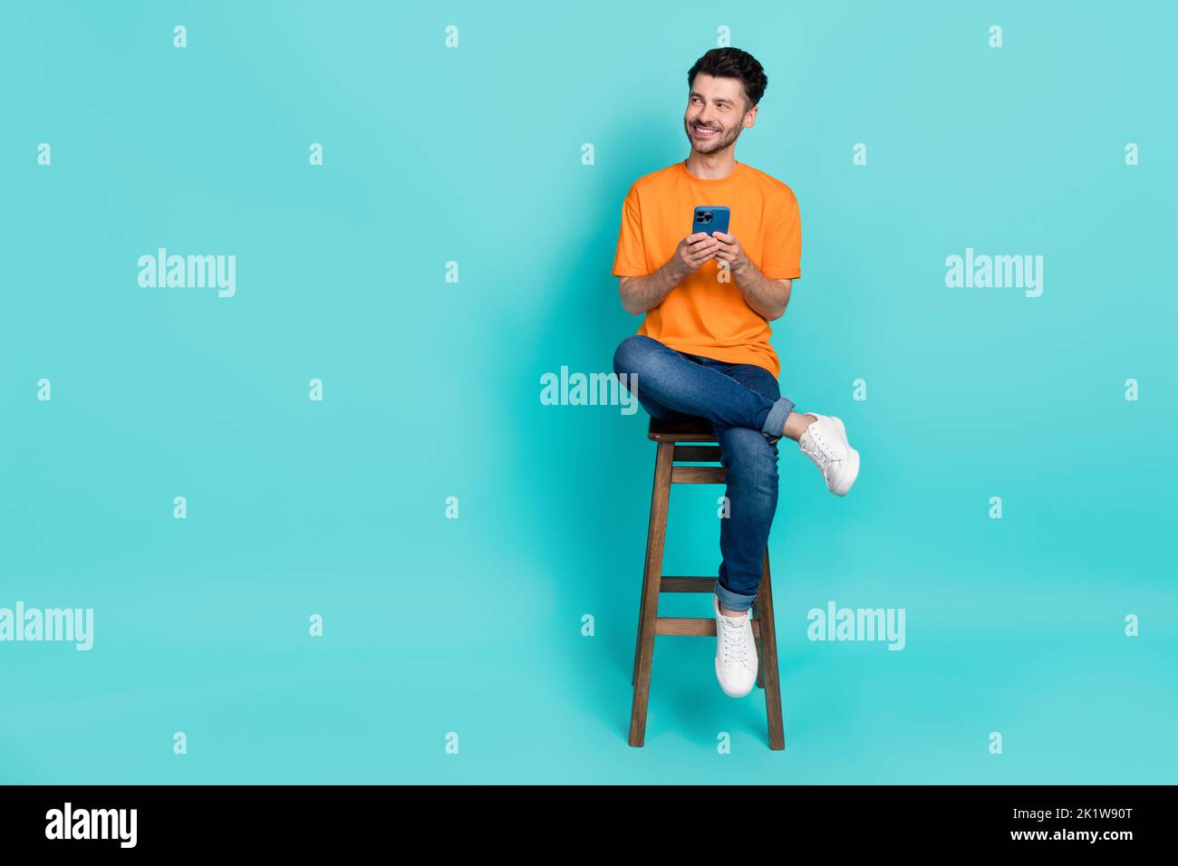 Full length photo of guy blogger sit chair using smart gadget look ...