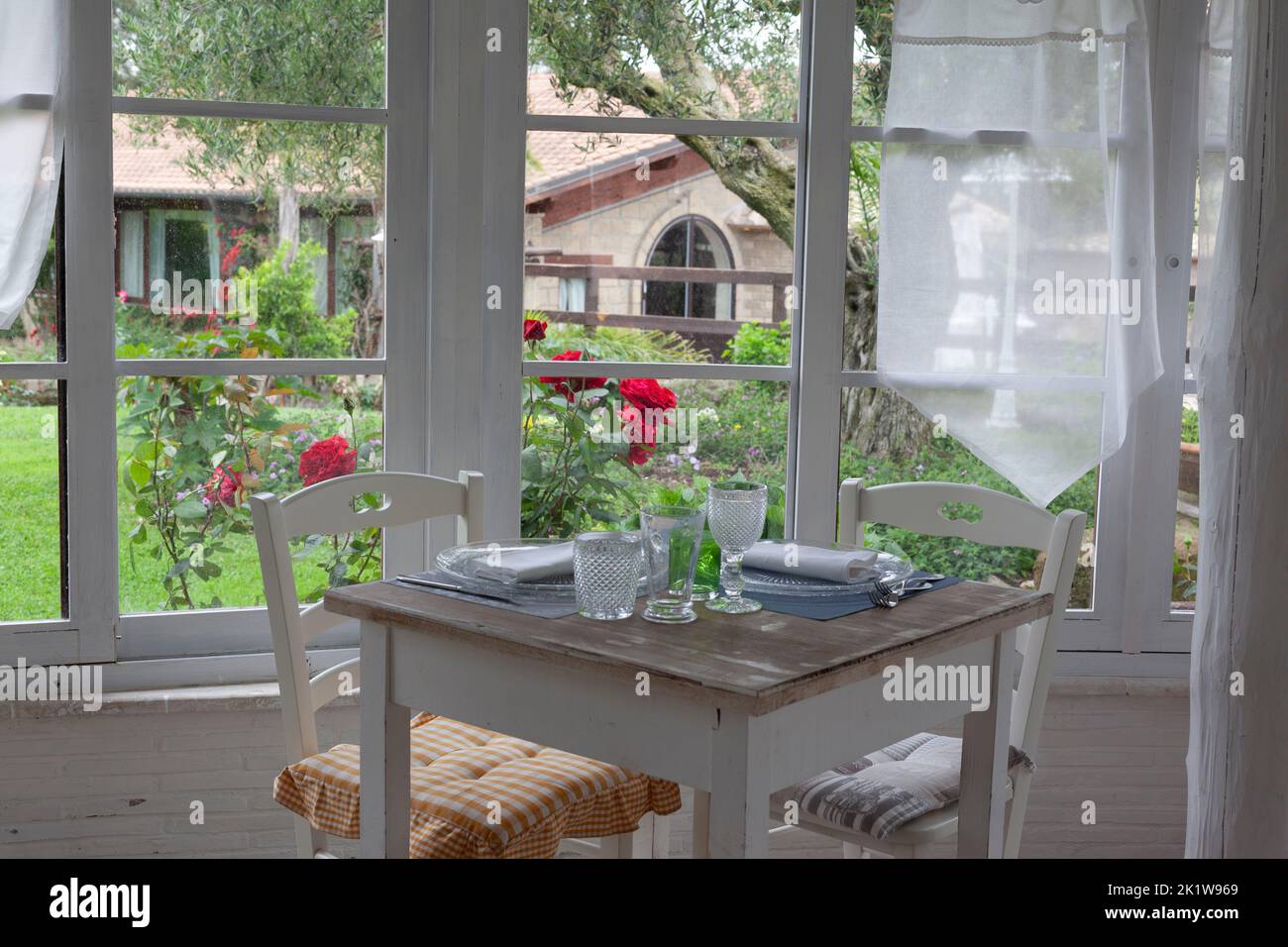 lunch set table in a bay window Stock Photo - Alamy