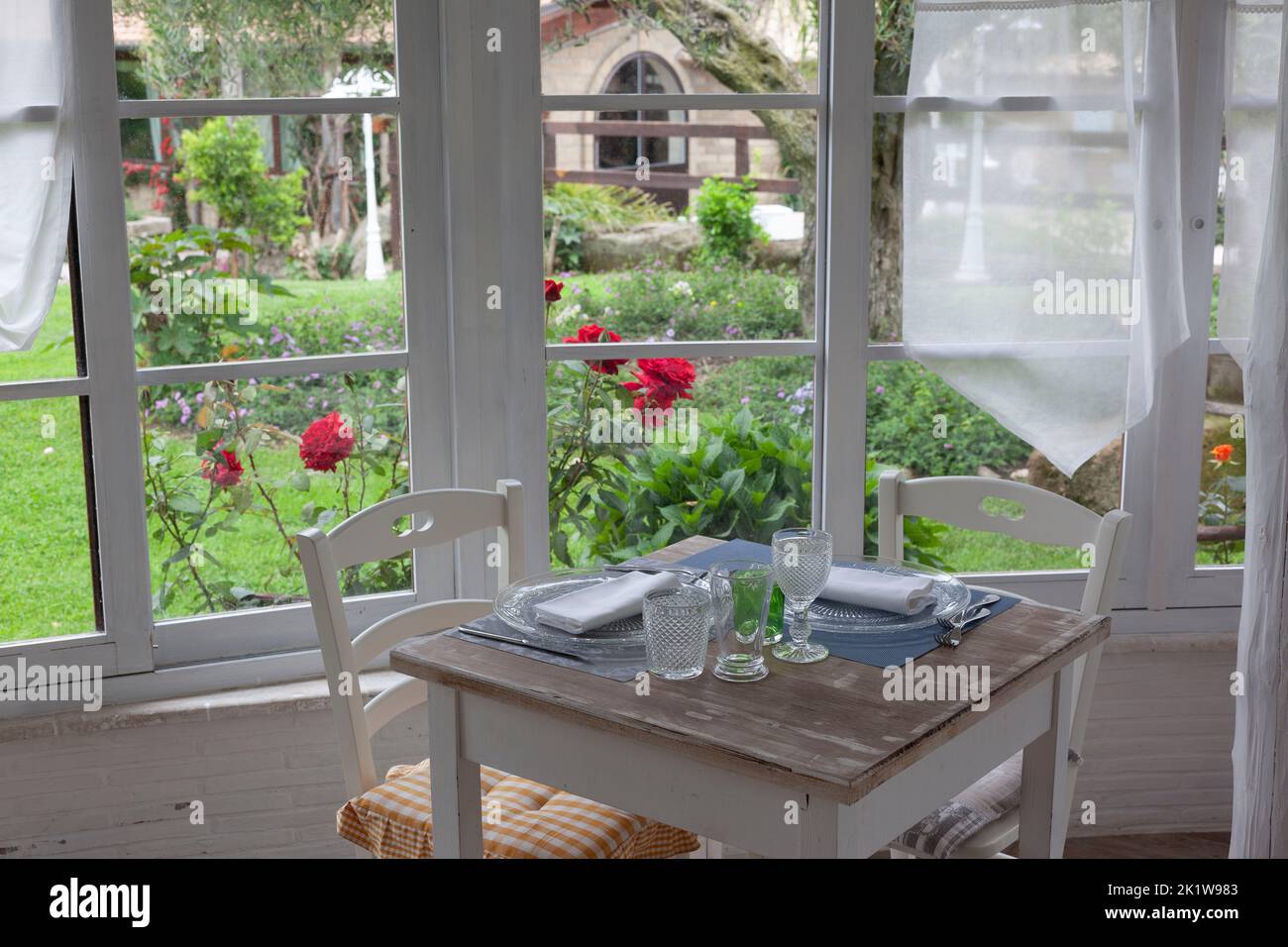 lunch set table in a bay window Stock Photo - Alamy