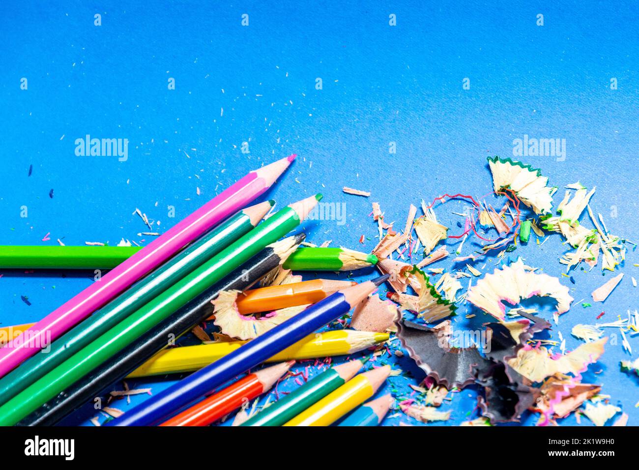 Colored pencils isolated on blue background. Close up. Sharpened pencil ...