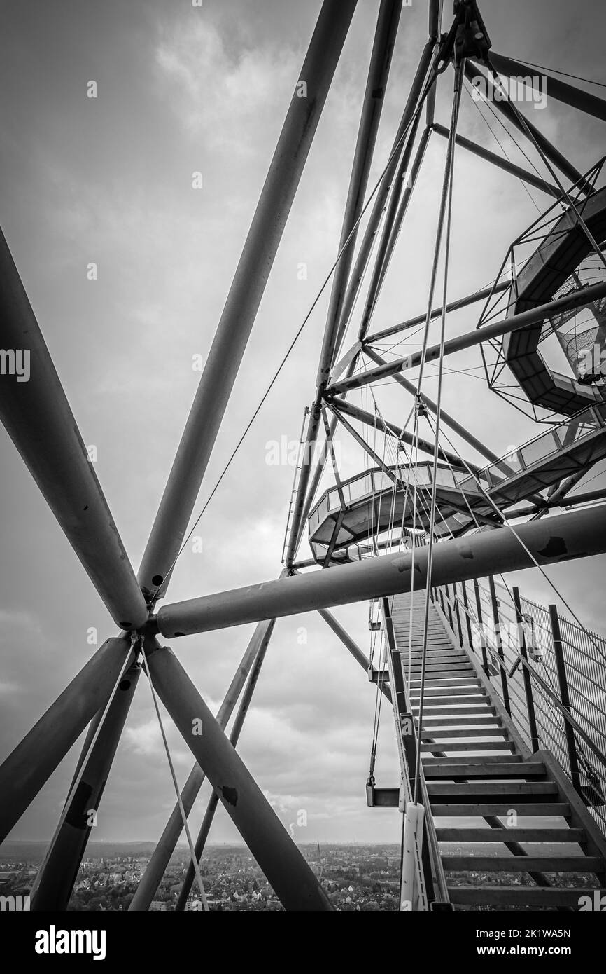 A vertical black and white shot of a viewing platform in a cloudy ...