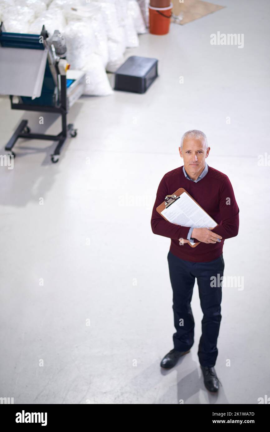 Im in charge of this operation. Portrait of a factory manager standing ...